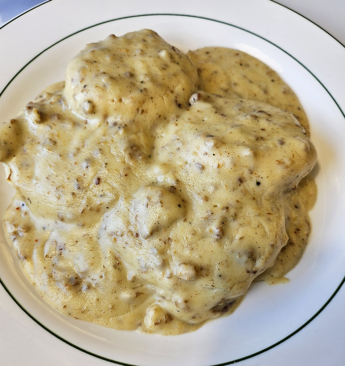 Biscuits and gravy so good they should require a permission slip. That pepper-flecked blanket of creamy goodness is what breakfast dreams are made of.