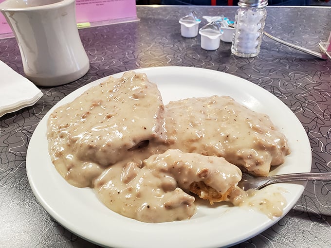 Biscuits swimming in creamy sausage gravy &ndash; this plate doesn't care about your diet plans or your arteries, just your immediate happiness.