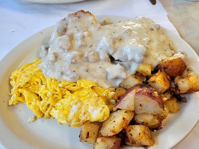 Country gravy cascading over eggs and potatoes&mdash;comfort food that hugs your soul before you've taken the first bite.