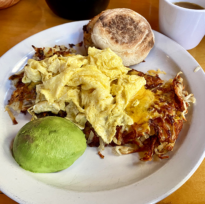 This isn't just breakfast&mdash;it's edible architecture. Perfectly scrambled eggs, crispy hash browns, fresh avocado, and an English muffin that deserves its own fan club.