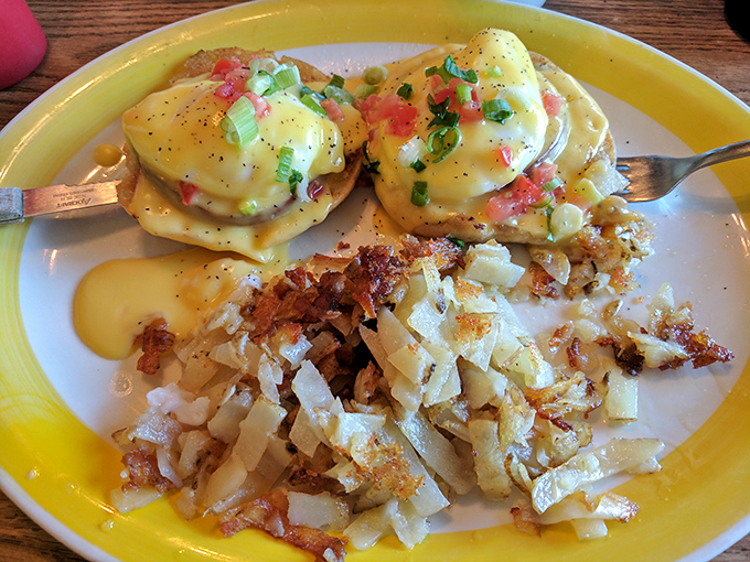 Eggs Benedict that would make a cardinal sin jealous&mdash;perfectly poached eggs draped in hollandaise with crispy hash browns standing guard.
