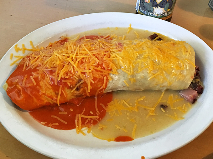 Behold the breakfast burrito in its natural habitat—half red, half green chile, all delicious. This isn't just breakfast, it's edible artwork.
