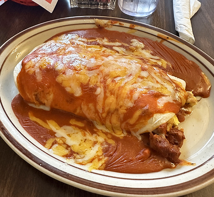 Not all heroes wear capes—some come wrapped in flour tortillas, smothered in red chile sauce, and require both hands to eat.