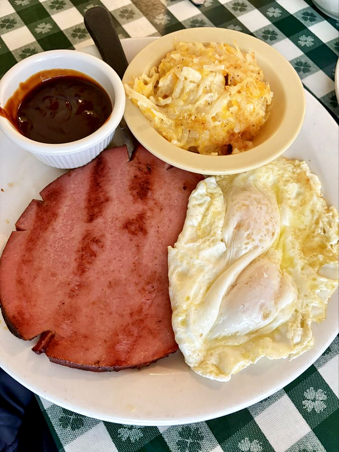 Country ham, sunny eggs, and hash brown casserole &ndash; the holy trinity of Southern breakfast, arranged like edible artwork. 