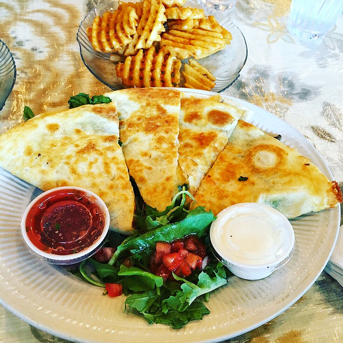 The legendary breakfast quesadilla in all its glory &ndash; perfectly grilled tortilla, colorful fillings, and those little cups of happiness on the side.