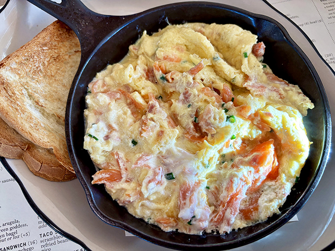 Eggs and salmon having a morning rendezvous in a cast iron skillet&mdash;a breakfast affair so perfect you'll want to write home about it.