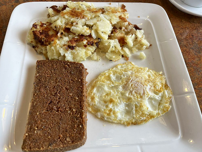 Pennsylvania breakfast perfection: crispy home fries, a perfectly fried egg with edges just shy of lacy, and scrapple—that uniquely regional treat that divides tourists but unites locals.