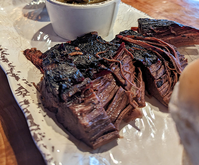 Behold the brisket in all its bark-encrusted glory. That smoke ring isn't just for show&mdash;it's a pink badge of honor earned through patience.