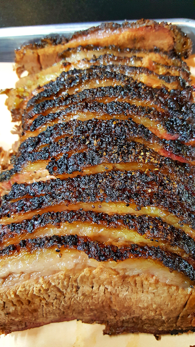 Behold the brisket in all its glory&mdash;that bark, that smoke ring, that perfect rendering of fat. This isn't food; it's edible architecture.