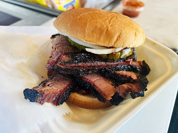 The brisket sandwich isn't just a meal, it's an architectural achievement of smoke-ringed perfection between two humble buns.