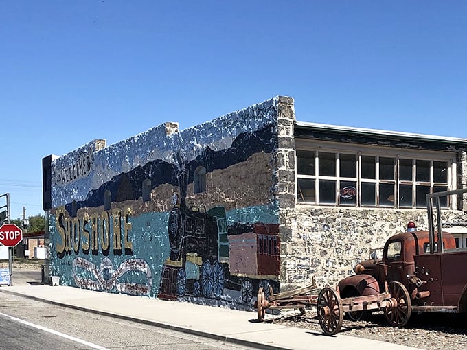 This colorful mural celebrates Shoshone's heritage against a backdrop of brilliant Idaho blue skies, with a vintage truck standing guard like a rusty sentinel.