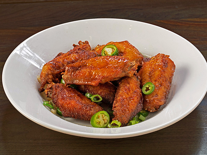 These aren't your average sports bar wings&mdash;they're crispy, glazed Malaysian-style flavor bombs topped with fresh jalape&ntilde;os that will make Buffalo weep with jealousy.