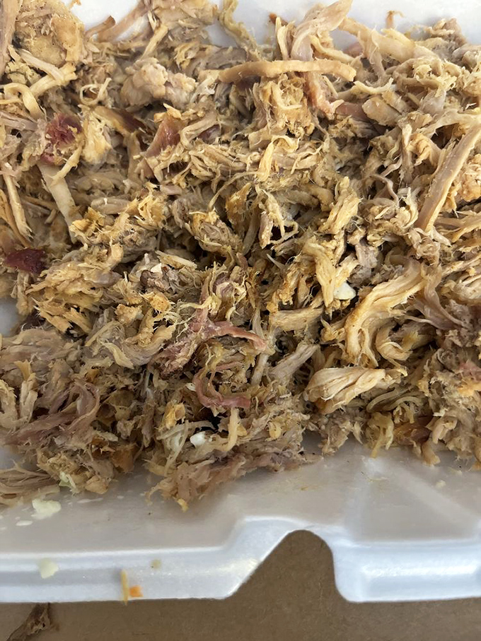 Behold the holy grail of pulled pork—tender strands of smoky perfection that would make even a vegetarian's resolve waver momentarily.