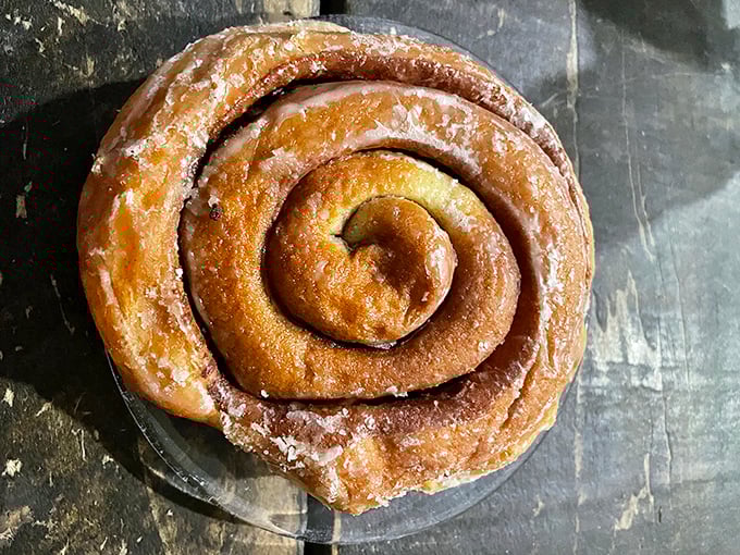 This cinnamon roll isn't just a pastry; it's a spiral-bound love letter to butter and spice. Worth every sticky finger.
