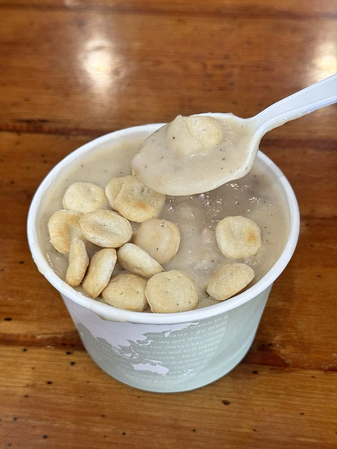 Clam chowder that doesn't mess around—creamy, hearty, and dotted with oyster crackers that bob like tiny lifeboats in a sea of comfort.