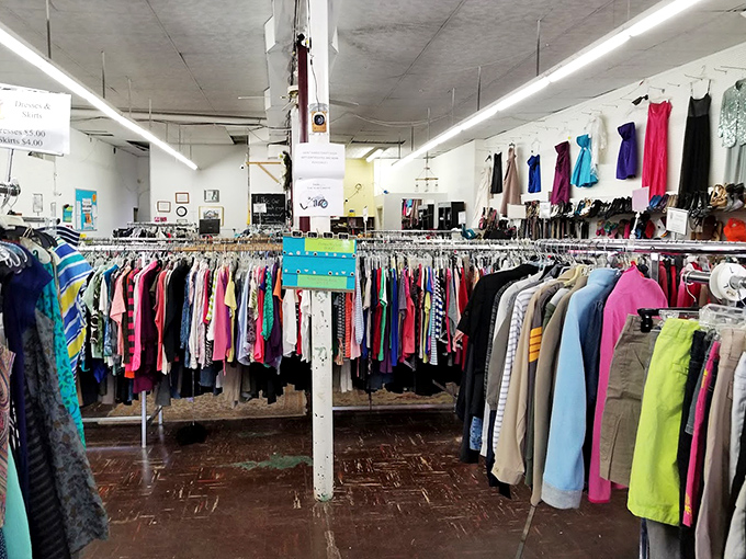 Rainbow rails of possibility—where your next favorite outfit hangs patiently between a stranger's past and your stylish future.