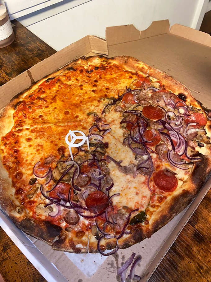 Half plain, half loaded—the compromise that ends marriages and starts them. That perfect char on the crust is what pizza poets write sonnets about.