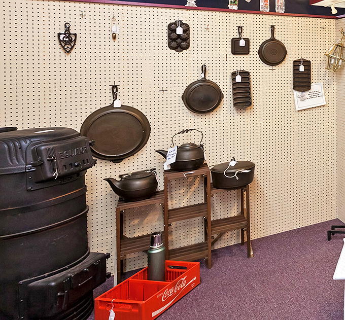 Cast iron cookware that could survive the apocalypse hangs alongside vintage kettles. Grandma would approve of this display that puts modern non-stick to shame.