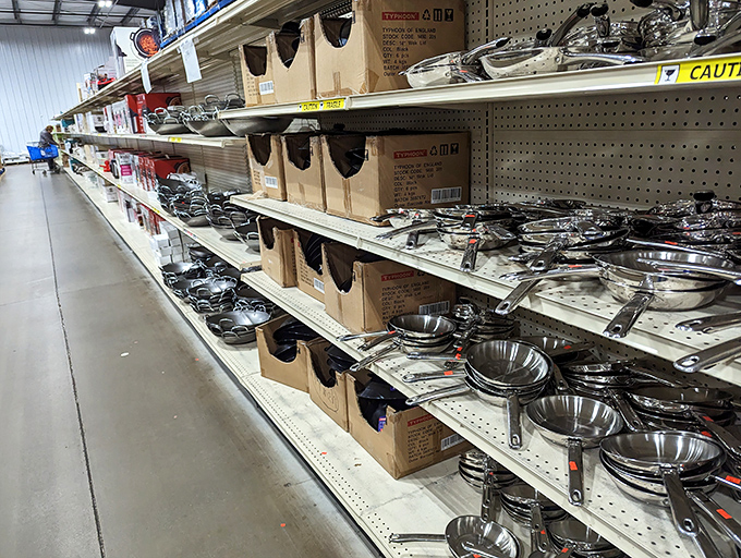 Pots and pans gleam under fluorescent lights like an armory for culinary warriors. Even professional chefs would pause here, contemplating the possibilities of discounted stainless steel.
