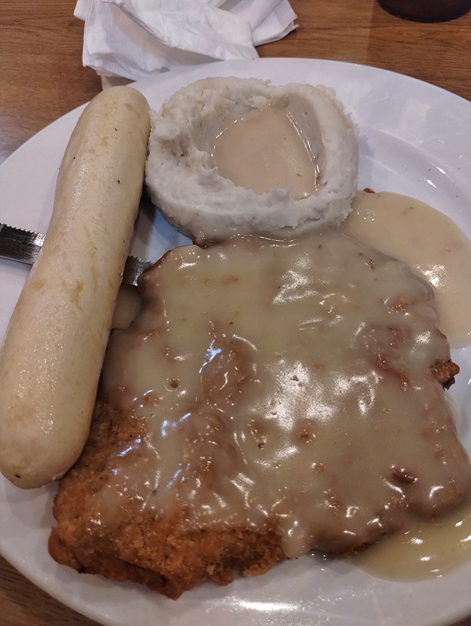 Country-fried steak swimming in gravy with a side of mashed potatoes &ndash; the holy trinity of heartland cuisine.