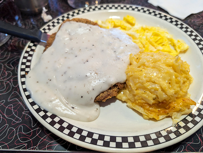 Country fried steak smothered in gravy that cascades like a waterfall of comfort. Paired with hash browns that achieve that perfect crisp-tender balance.