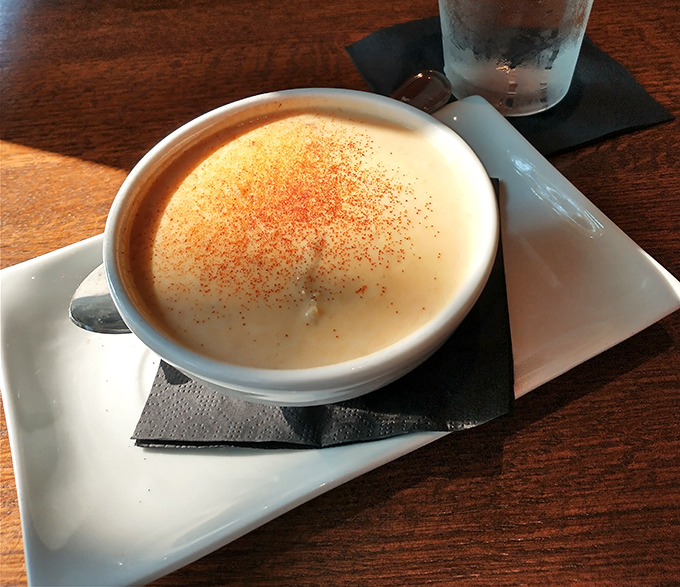 The crab bisque arrives like a velvet sunset &ndash; creamy, copper-hued perfection dusted with spices that whisper, "You made the right choice."