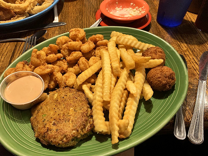These golden-brown crab cakes aren't just appetizers; they're edible proof that sometimes the simplest pleasures in life come with a side of perfect french fries.
