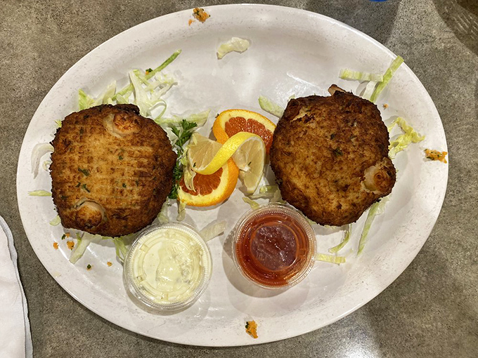 Crab cakes so perfectly golden they deserve their own trophy, served with the obligatory citrus wedges that nobody actually squeezes.