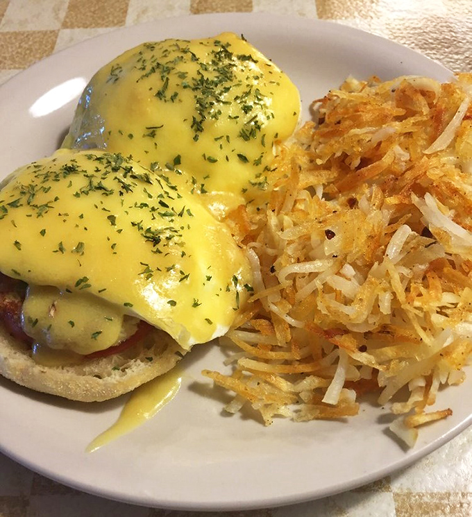 Behold the legendary crabcake benedict in all its glory! Golden hollandaise cascades over plump crabcakes while those hash browns stand at attention, ready for their supporting role.