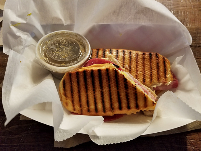 This isn't just a Cuban sandwich; it's a diplomatic mission between bread nations, complete with grill marks that deserve their own passport.