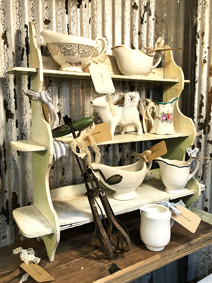 Grandmother's china cabinet comes to life with delicate gravy boats and vintage serving pieces, each tagged and waiting for their next dinner party.