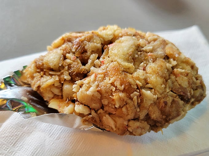 This crab cake isn't trying to impress anyone with fancy presentation, yet somehow manages to impress everyone with its perfect golden-brown crust and chunky interior.