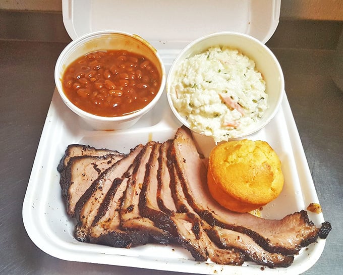 Smoke-kissed brisket with baked beans and potato salad&mdash;proof that sometimes the most photogenic meals come in the humblest containers.