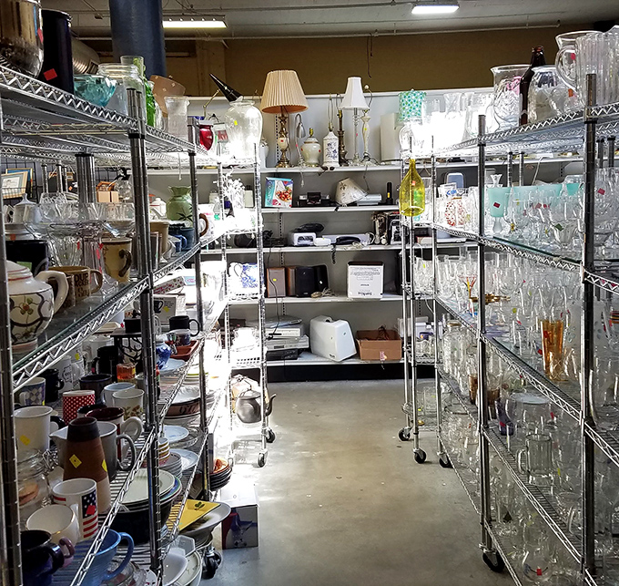 Exposed ductwork and industrial chic meet rainbow rows of potential. Every hanger holds a story waiting for its next chapter.