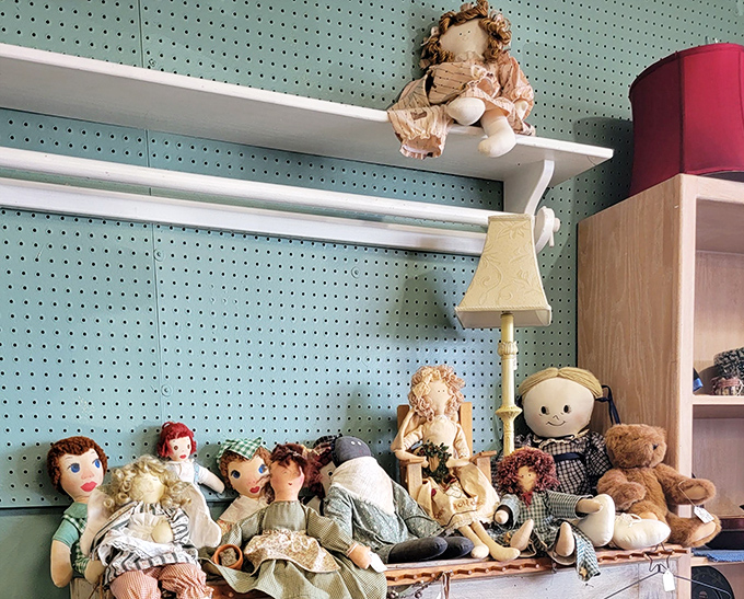 The doll collection watches with silent nostalgia from their perch. Each fabric face holds childhood memories for someone, waiting to create new ones.