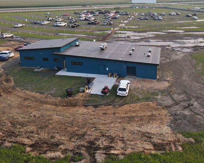 The blue concession building stands like a cinematic oasis in Nebraska's vast landscape, welcoming movie lovers to this rural retreat.