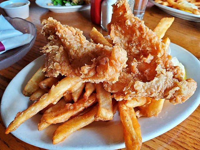 Golden-battered fish perched atop a mountain of crispy fries&mdash;this isn't just food, it's edible architecture designed by someone who understands true happiness.