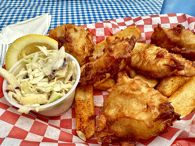 Golden-battered perfection that shatters with each bite. This fish and chips platter with creamy slaw is the Oregon coast on a red checkered tray.
