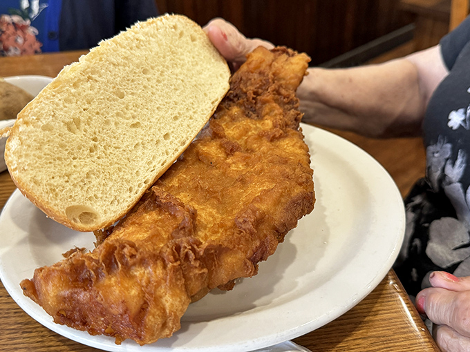Behold the star attraction: a fish sandwich so massive it requires strategic planning just to take the first bite. Architecture meets culinary art! 