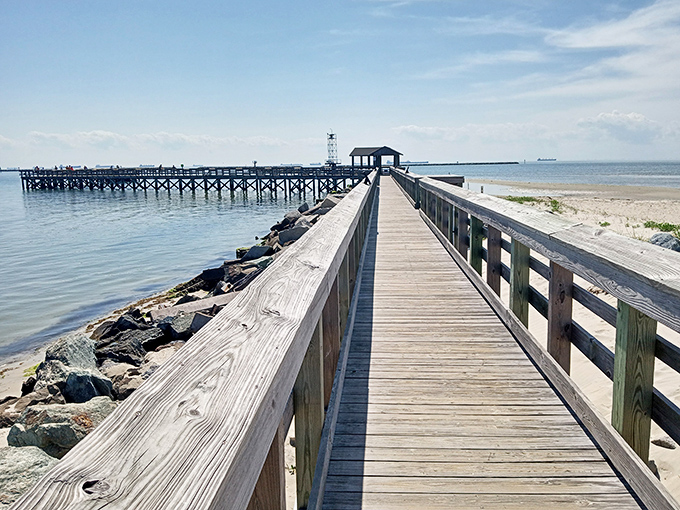 The fishing pier stretches toward the horizon like a wooden runway, inviting both serious anglers and sunset-chasers to venture out.