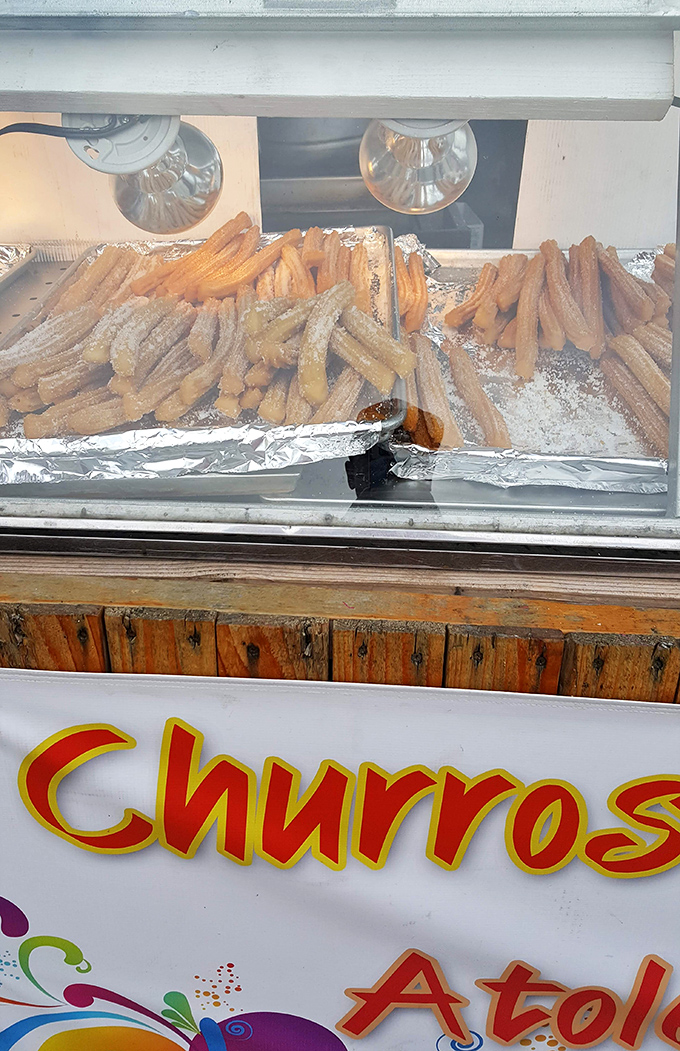 Golden churros basking under heat lamps &ndash; crispy, sugary lifelines for shoppers who've worked up an appetite through serious bargain hunting.