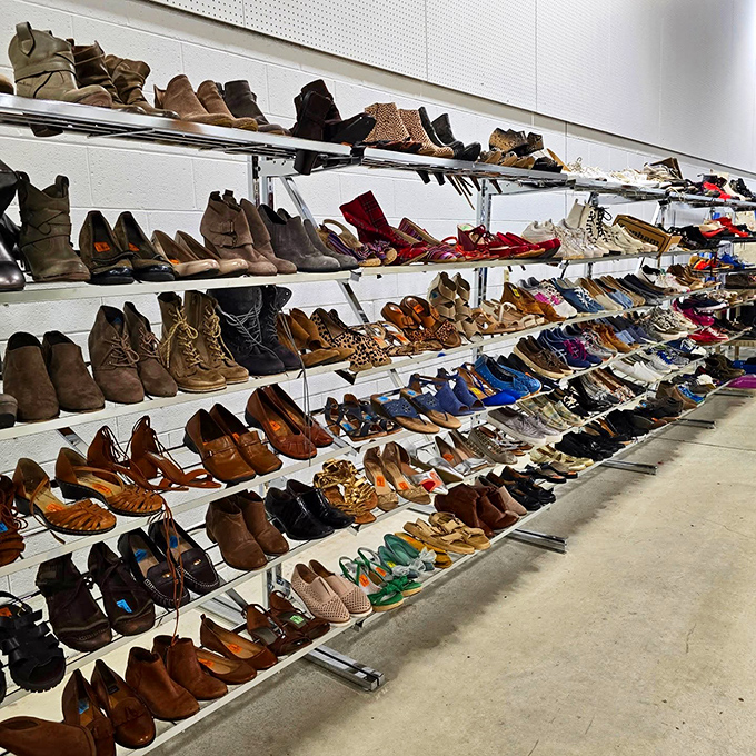 Rows of pre-loved shoes march along the wall, waiting to walk new paths with their next owners.