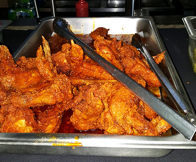 Behold the fiery glory! Each piece glistens with that signature cayenne-based coating that's simultaneously terrifying and irresistible, like a culinary roller coaster you can't wait to ride.