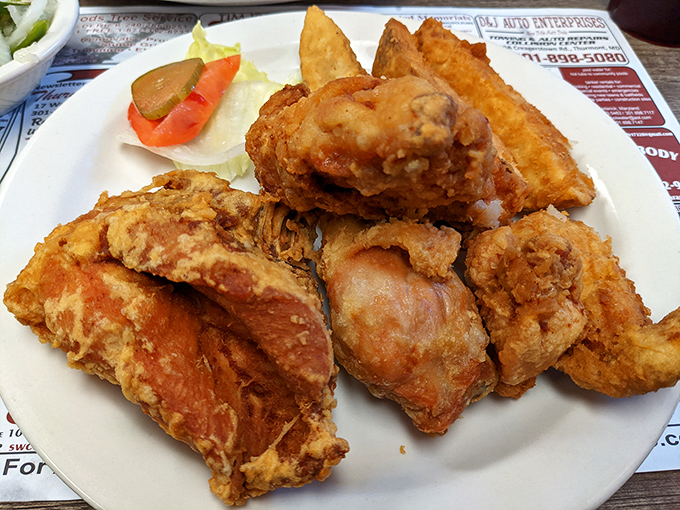 Behold the star attraction: golden-brown fried chicken with a crust so perfectly craggy it practically demands a moment of reverential silence.