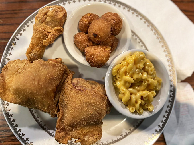 Golden-brown fried chicken that makes a satisfying crunch you can practically hear through the photo. Paired with hushpuppies and mac & cheese&mdash;the holy trinity.