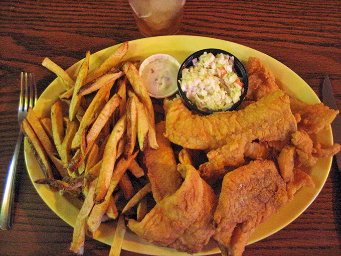 Golden perfection on a plate! This crispy fish with hand-cut fries and creamy coleslaw is what food dreams are made of—simple, honest, and utterly delicious.