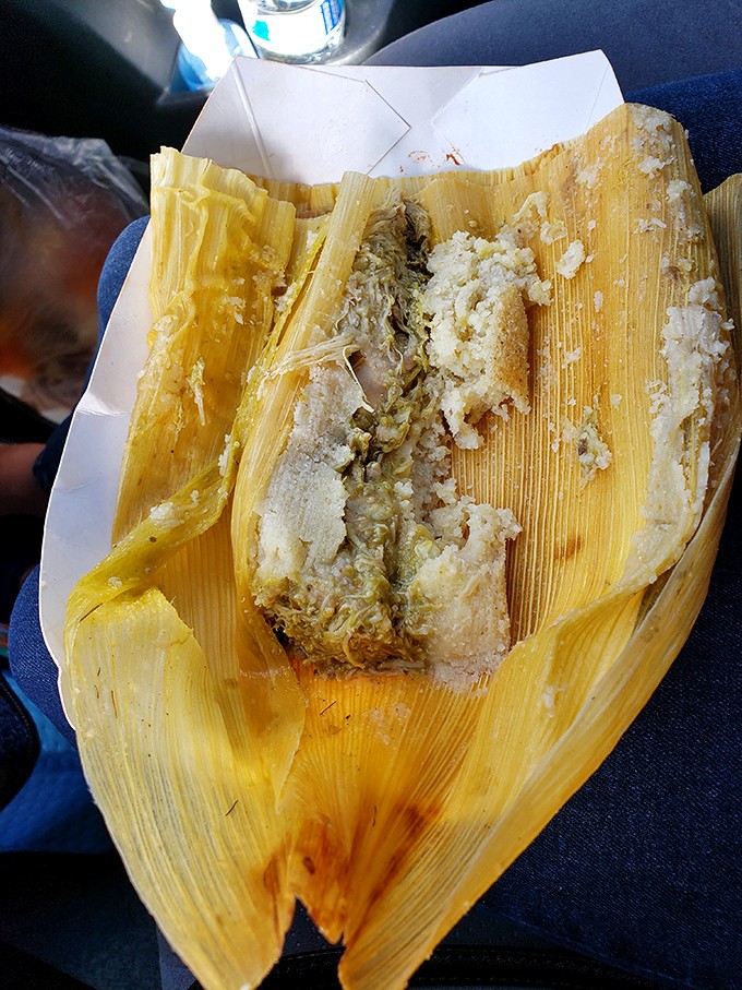 Unwrapping a tamale is like opening a present where the wrapping is part of the charm. This corn husk holds steamy, savory secrets within.