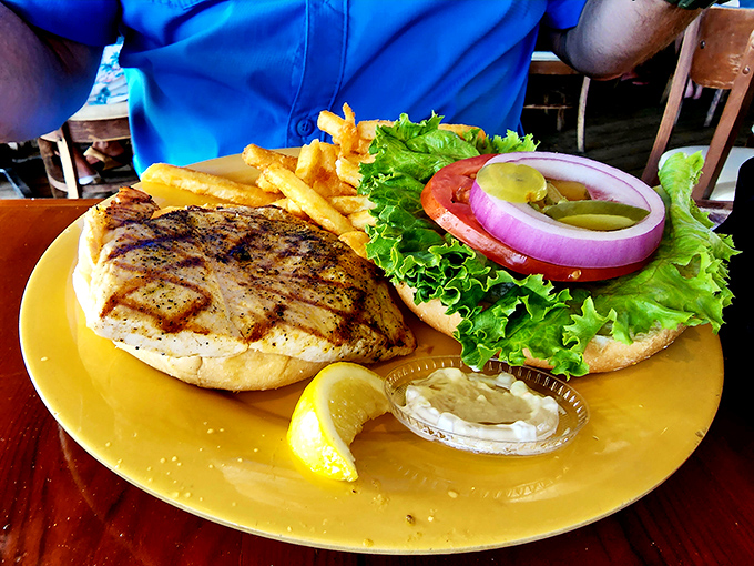 Behold, the star of our show! The grilled grouper sandwich arrives with all the fanfare it deserves&mdash;fresh, flaky, and flanked by crispy fries.