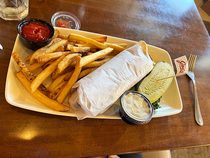 Not just a wrap, but a work of art. Golden fries stand at attention beside their wrapped companion, awaiting your first delighted bite.
