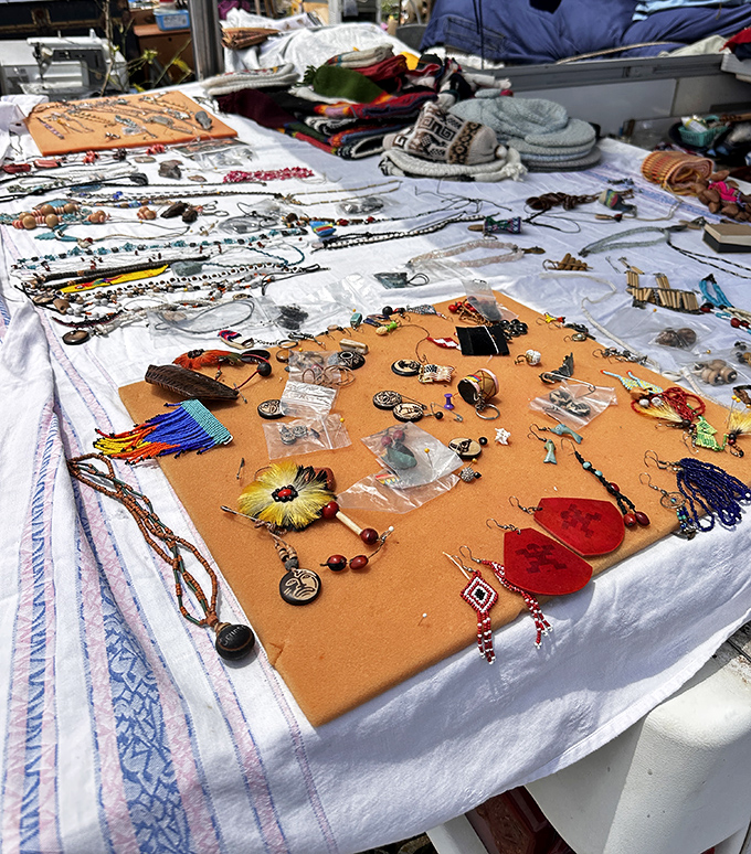 A kaleidoscope of handcrafted jewelry spreads across a vendor's table &ndash; each piece waiting for its perfect match.